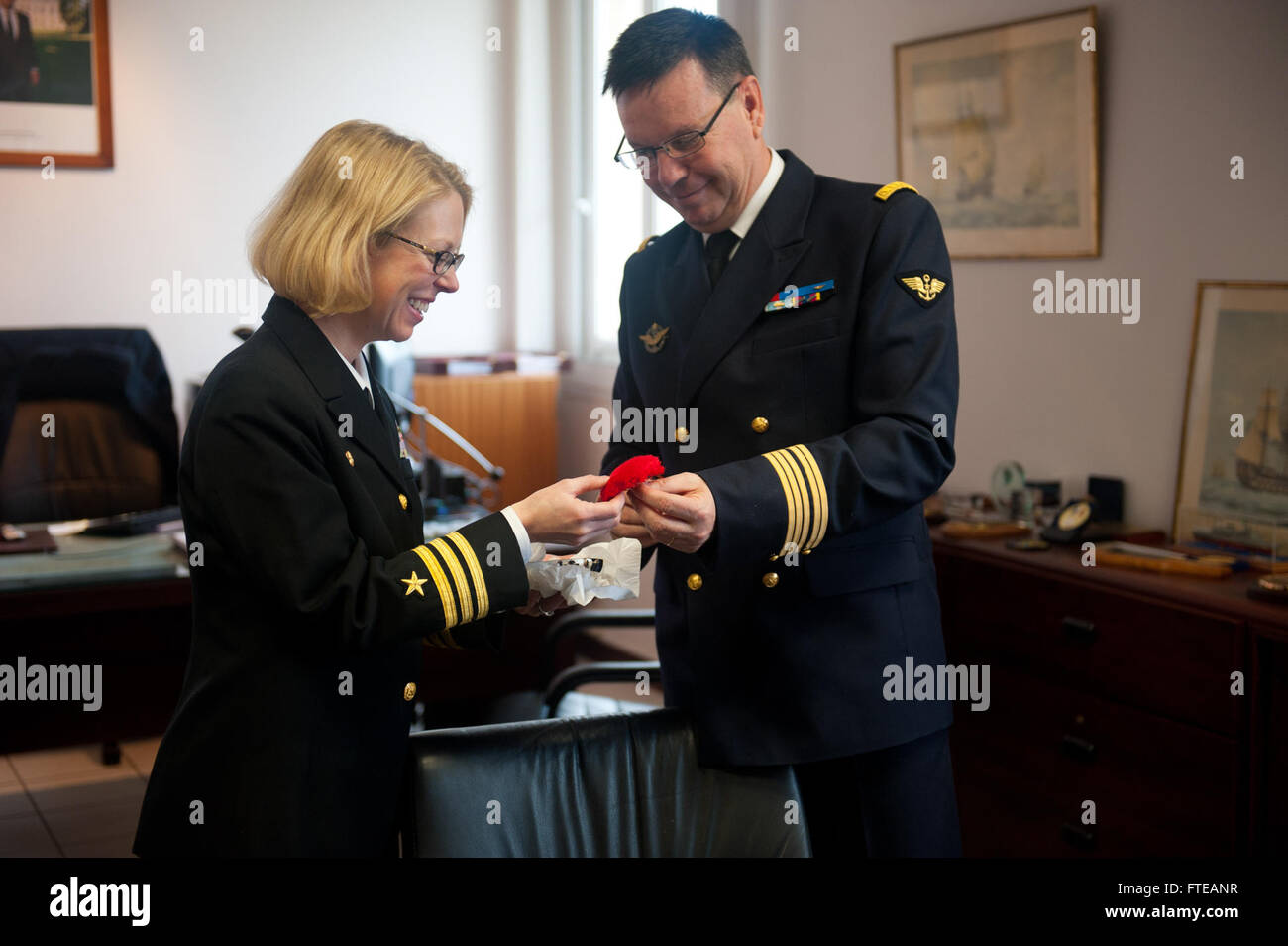 The photo shows Capt. Frederic Paillat of the French navy presenting ...