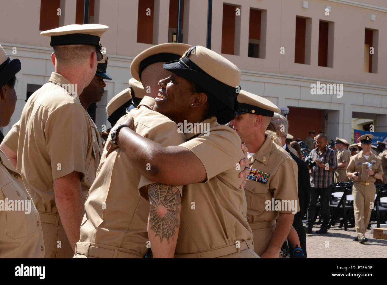 The image captures newly promoted Chief Petty Officers (CPO) at a ...