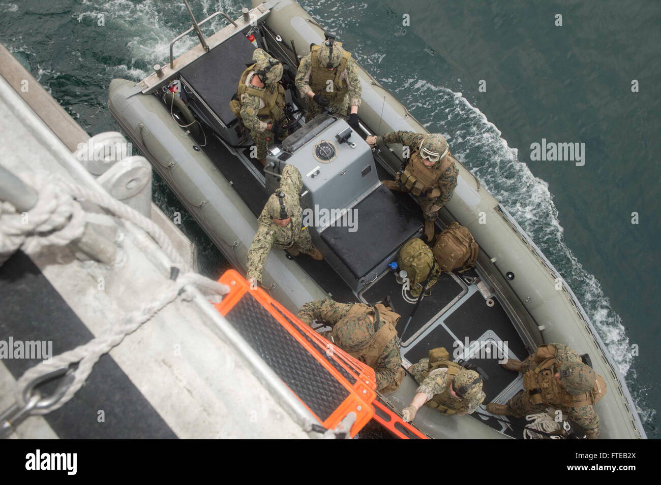 This photograph shows U.S. Marines boarding a boat from the USNS ...