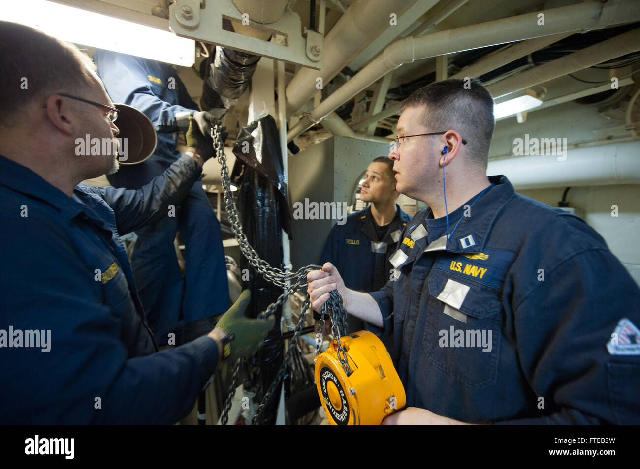 Sailors aboard the USS Arleigh Burke (DDG 51) conduct maintenance on ...