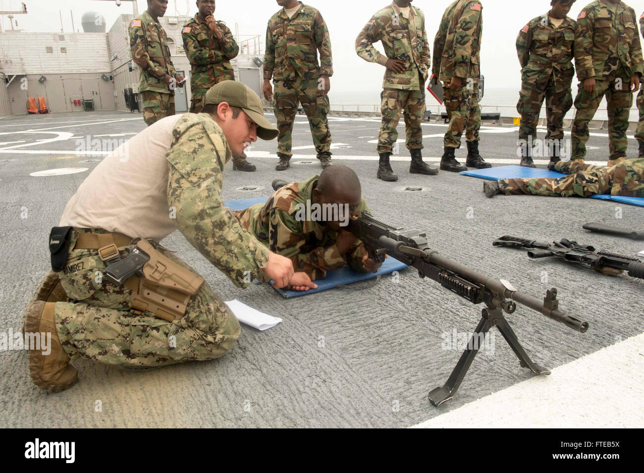 Gunner's Mate Seaman Enrique Ramirez provides instruction on the M240B ...