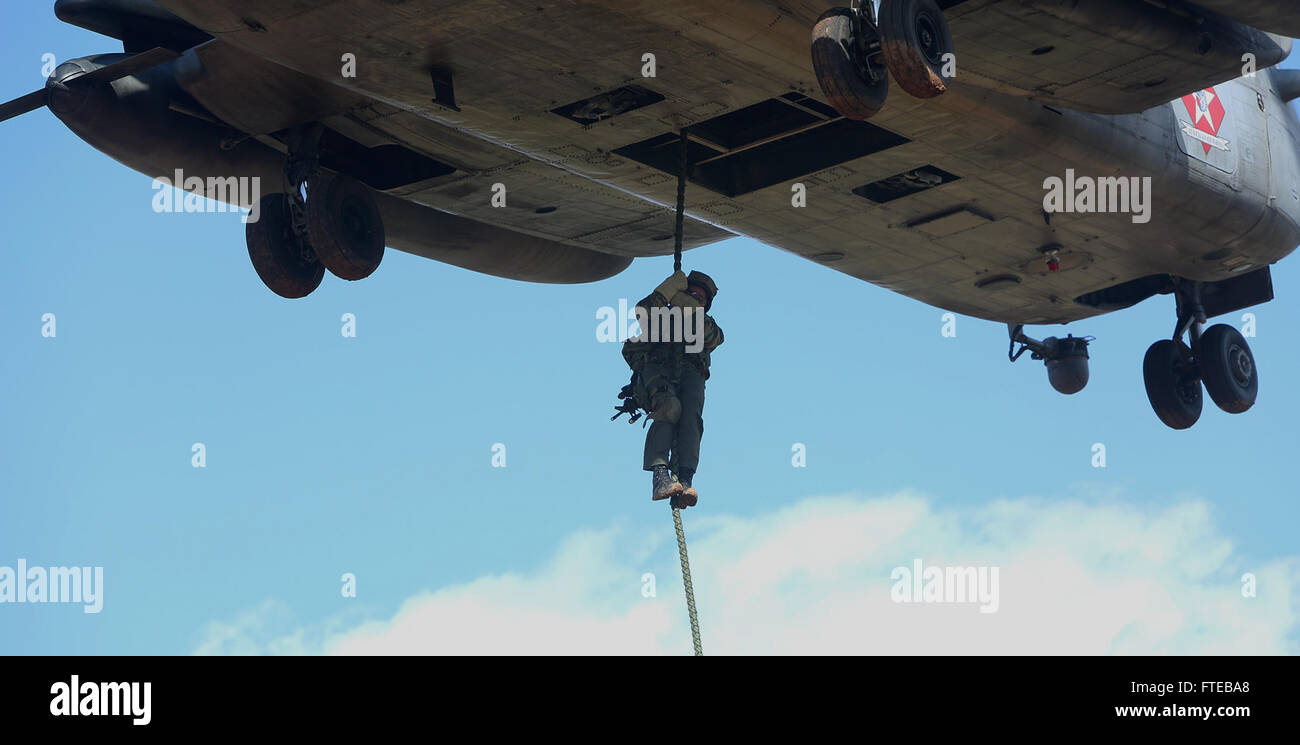 This image shows a member of the Hellenic Army fast roping from a CH ...