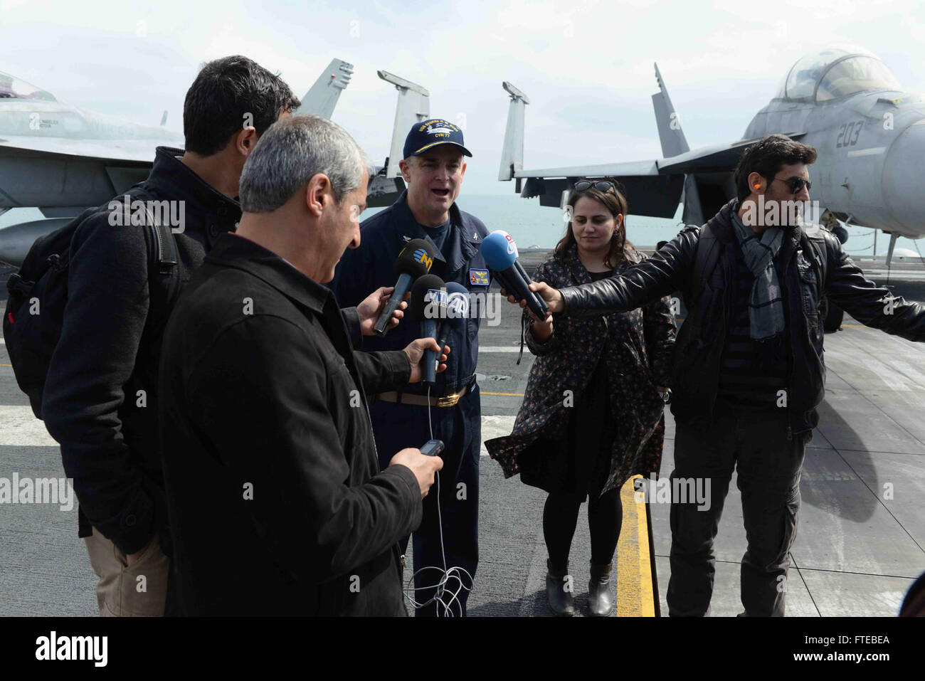 Captain Matthew Paradise, executive officer onboard USS *George H. W. Bush* (CVN-77), speaks to ...