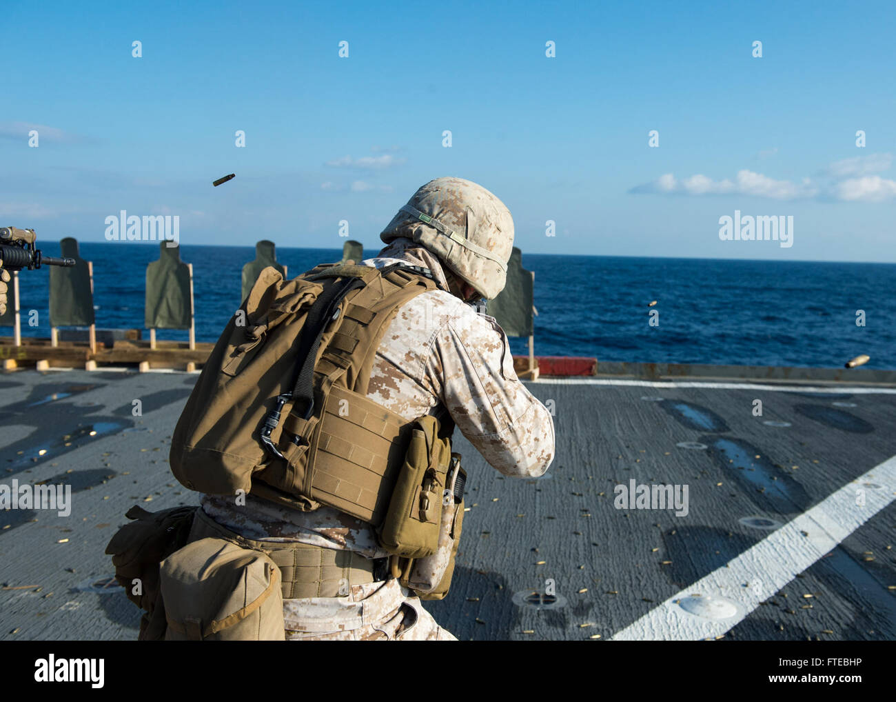 Marine Sgt. Anthony Stea participates in a live fire exercise aboard ...