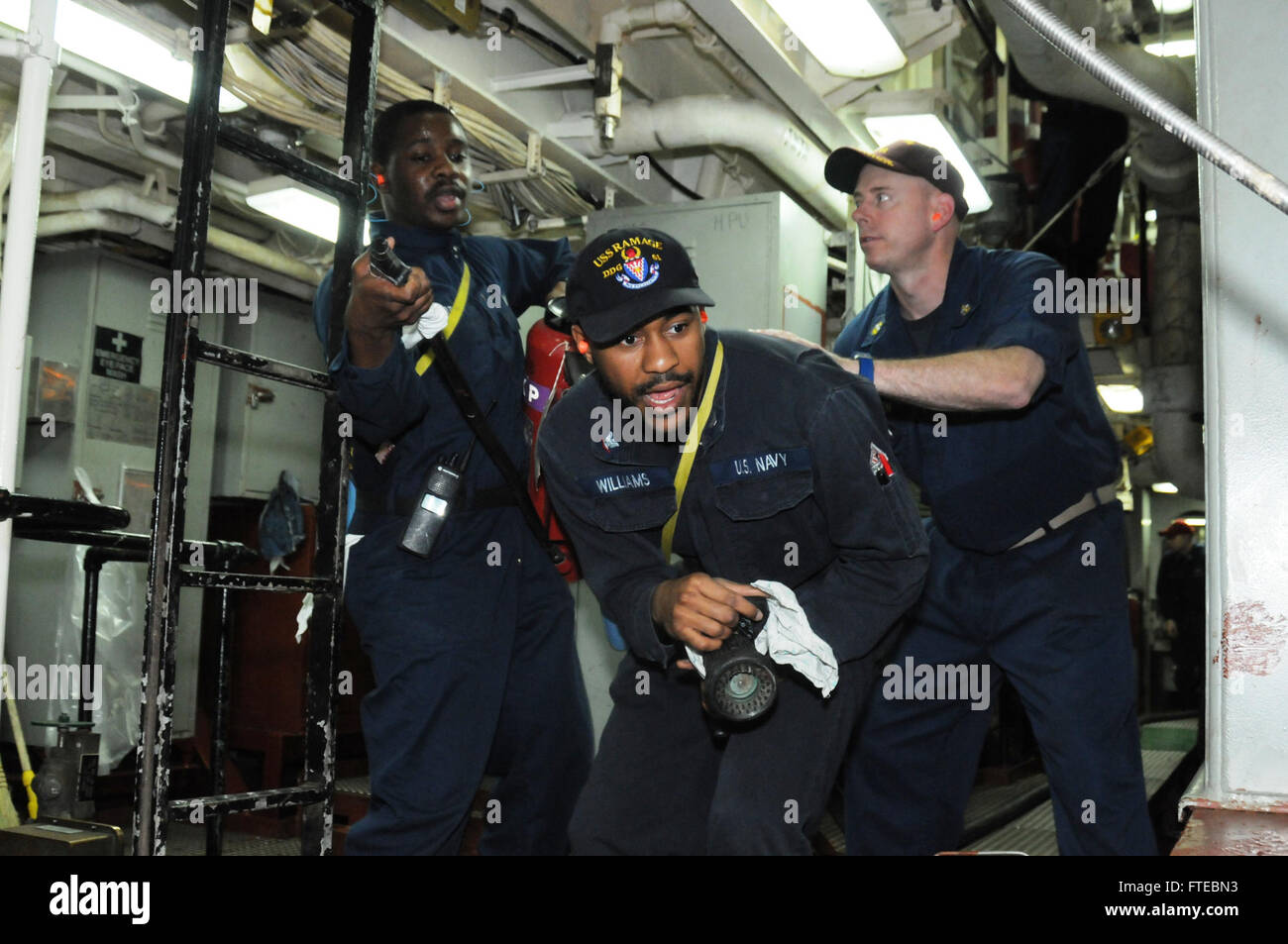 Sailors aboard the USS Ramage (DDG 61) conduct a simulated firefighting ...