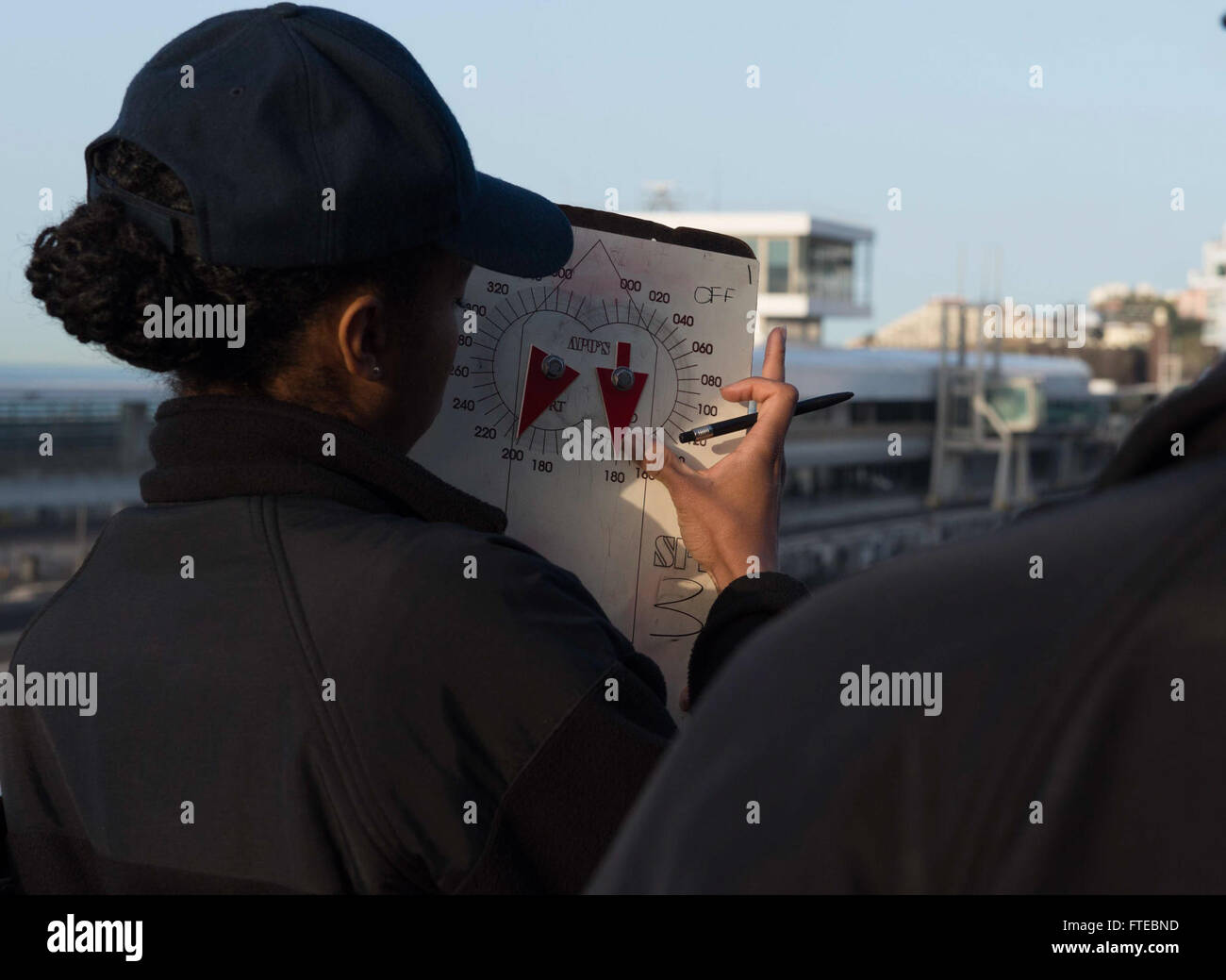Ensign Arabia Littlejohn records ship operations aboard the USS Simpson ...