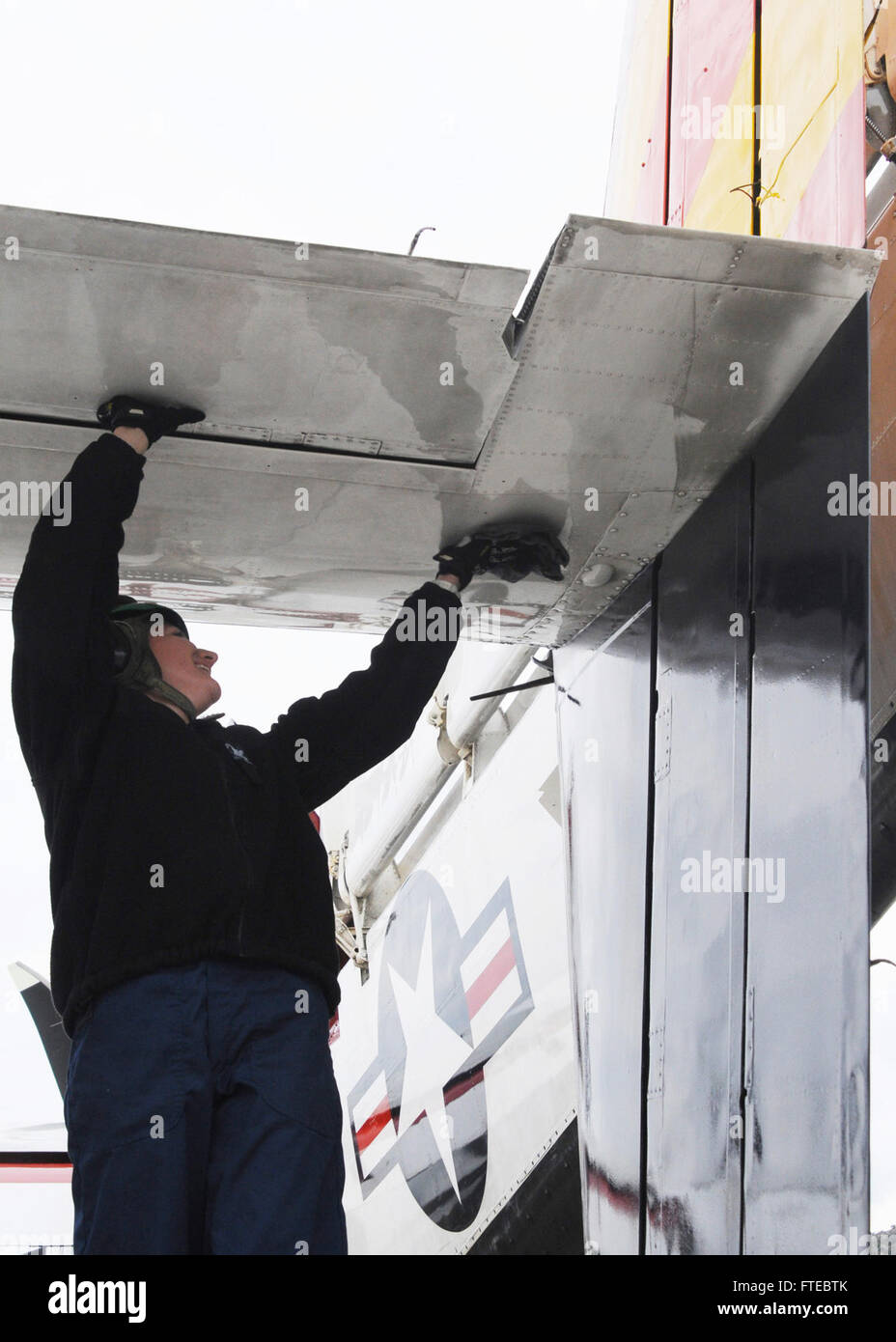 This U.S. Navy photo captures Aviation Machinist's Mate 2nd Class ...