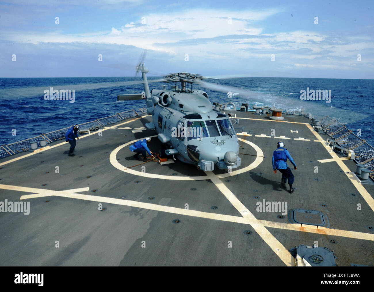 Sailors aboard the USS Ramage (DDG 61) refuel an MH-60R Sea Hawk ...