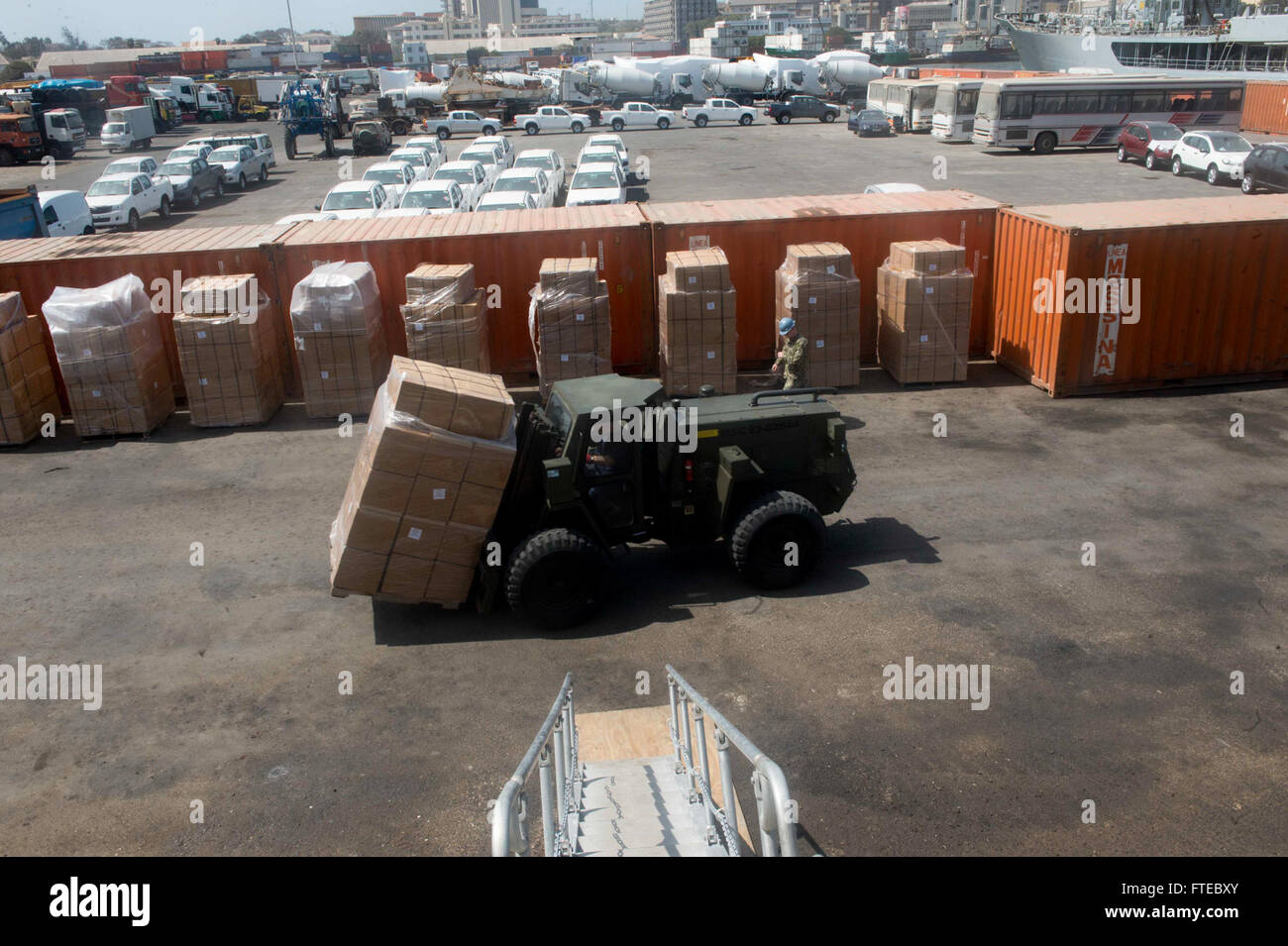 This photograph shows the offloading of Project Handclasp aid from the ...