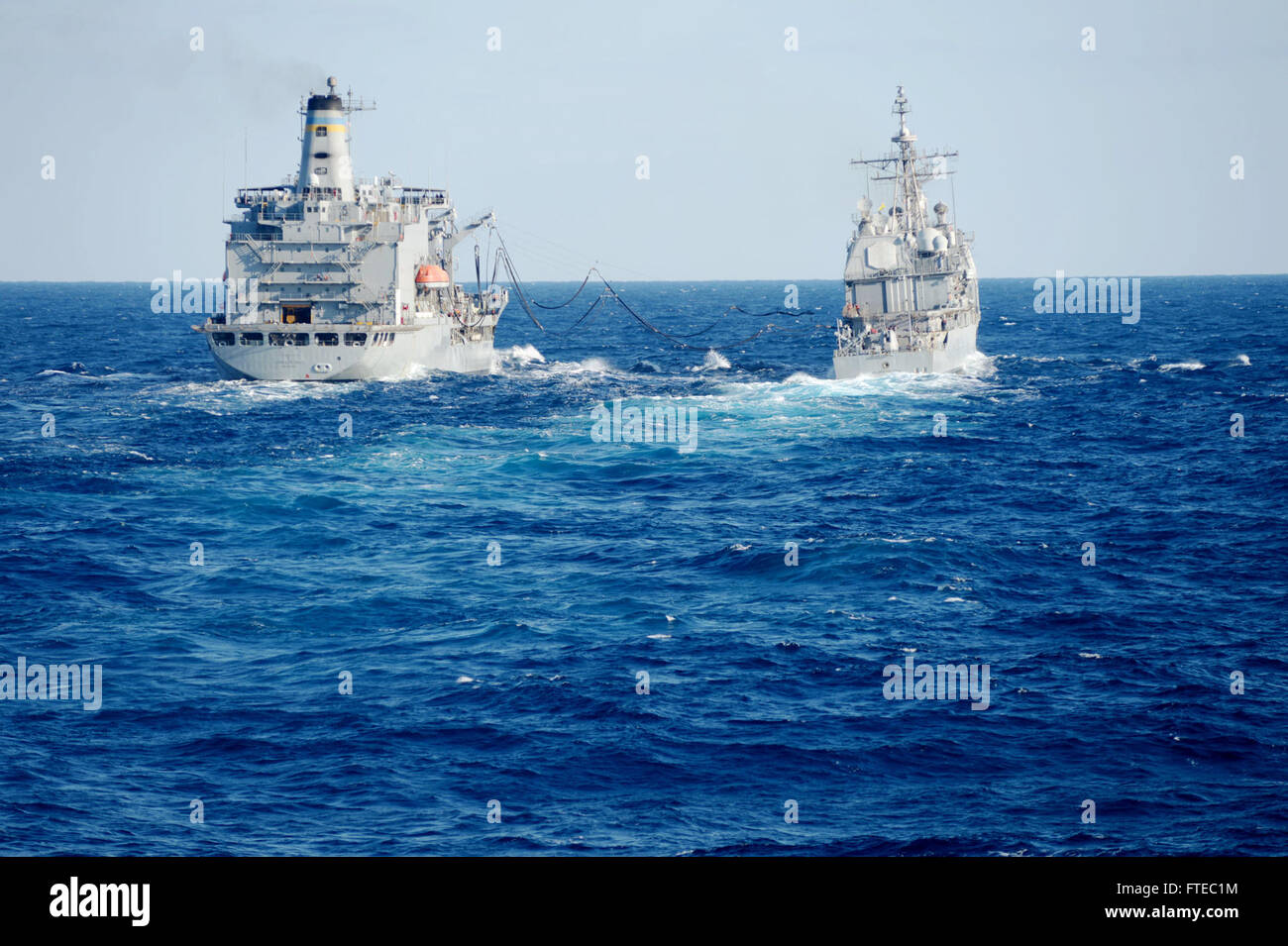 The USNS John Lenthall conducts an underway replenishment with USS ...