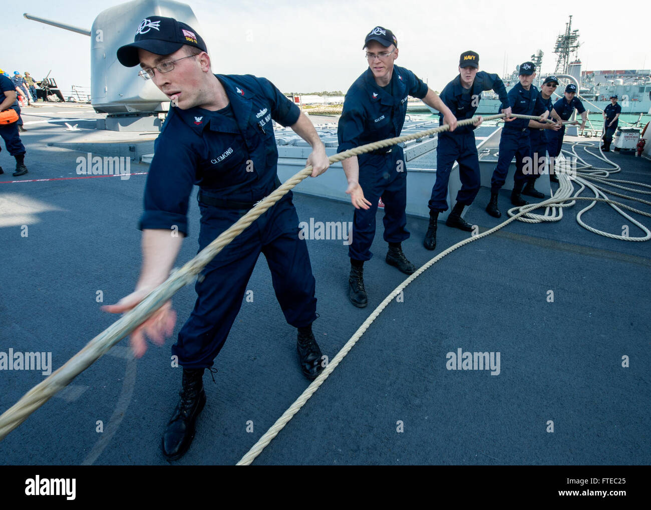 This photograph captures sailors aboard the USS Donald Cook preparing ...