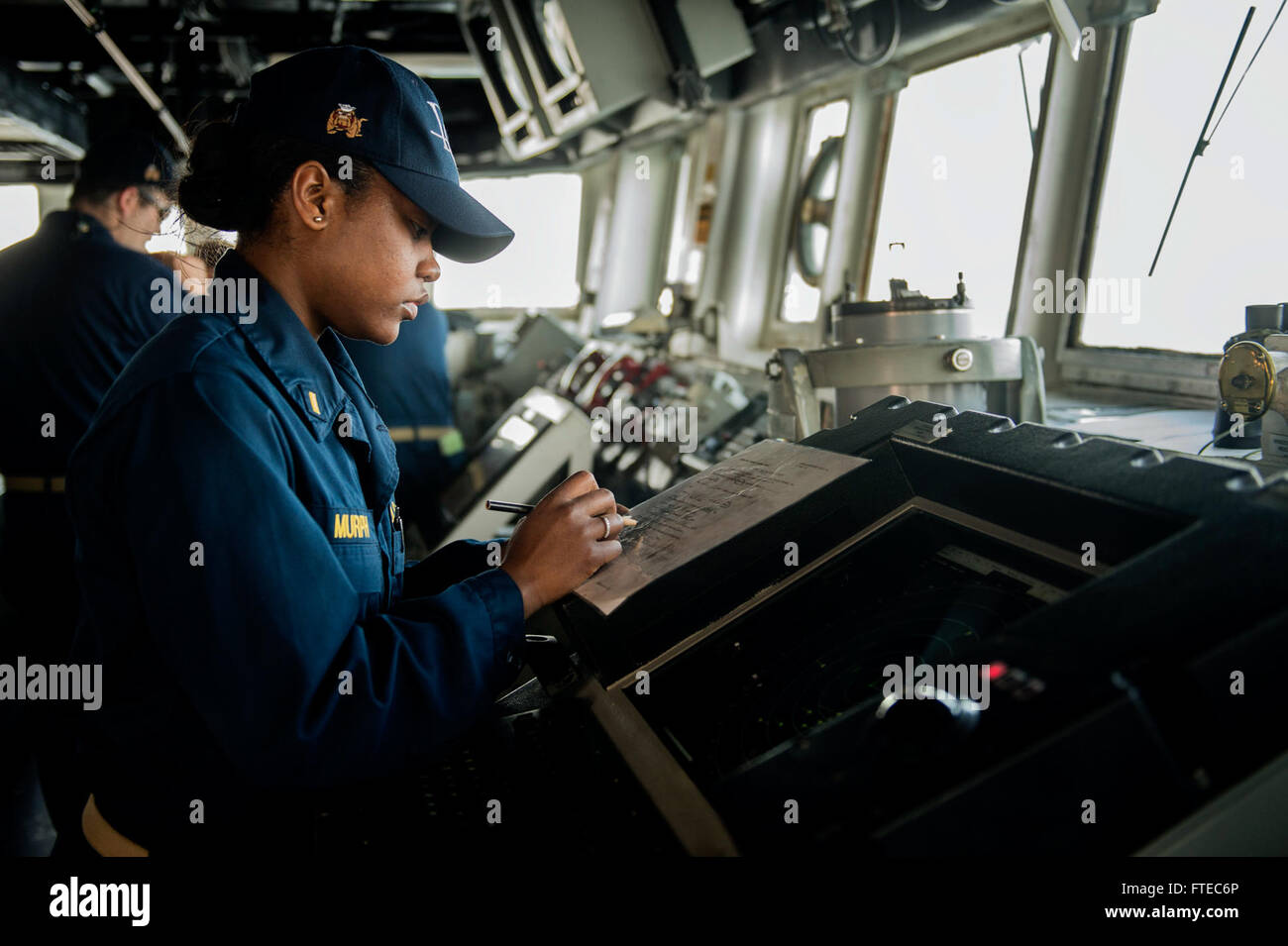 Ensign Mansfield Murph monitors the SPS-73 radar on the *USS Donald ...