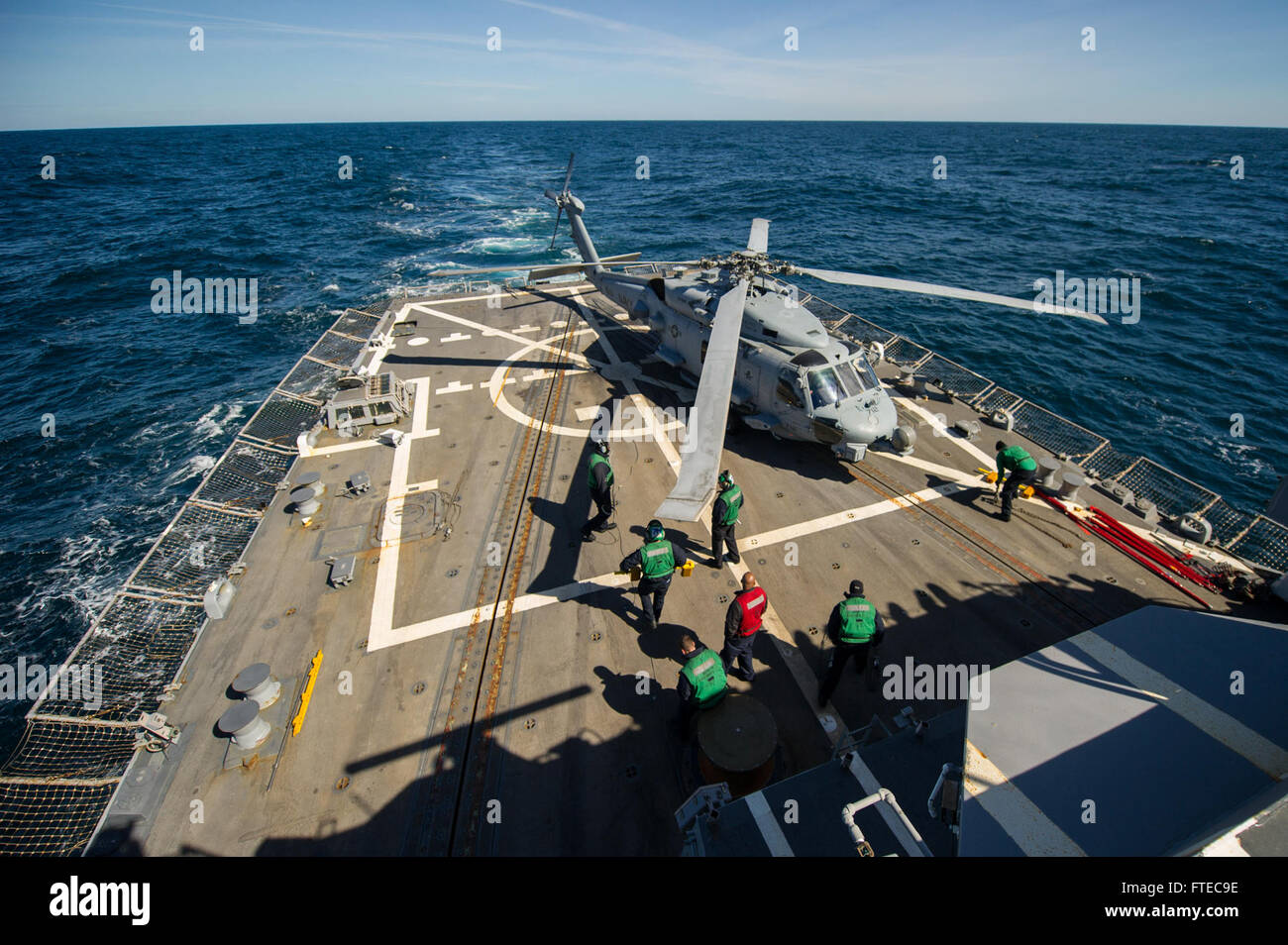 Sailors aboard the USS Truxtun (DDG 103) are seen preparing to stow an ...