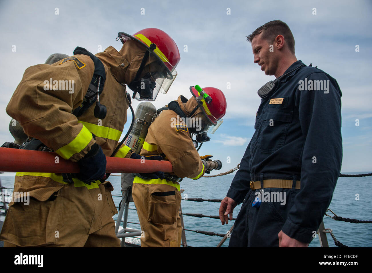 Chief Damage Controlman Joseph Thomas provides firefighting training to ...