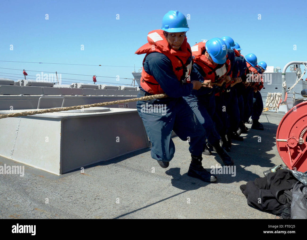 Sailors aboard the USS Ramage (DDG 61) conduct line handling on the ...