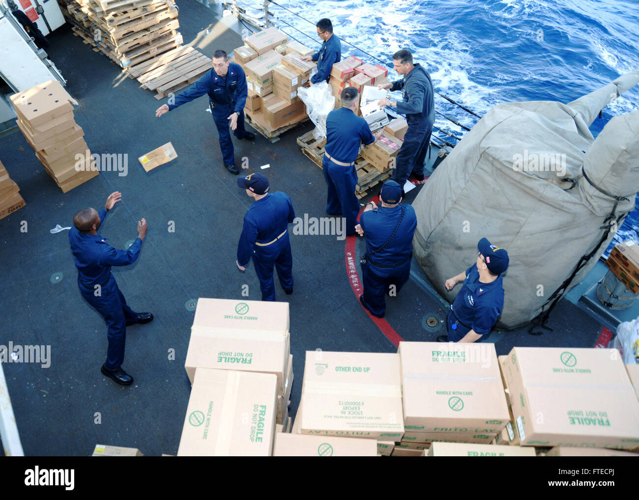 Sailors aboard the USS Ramage (DDG 61) engage in a replenishment ...