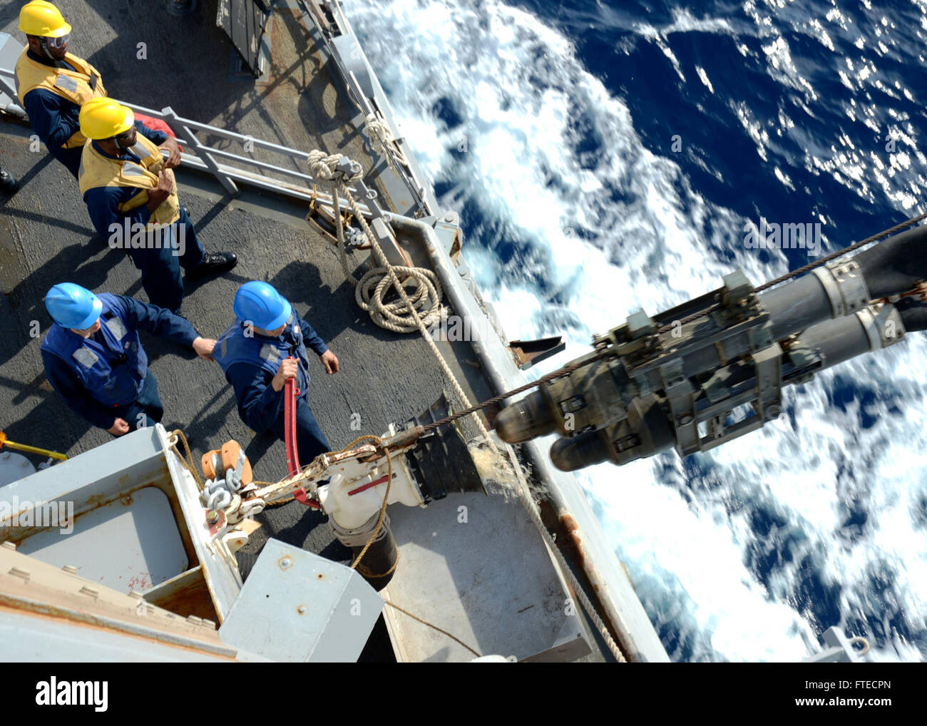 A sailor aboard the USS Ramage (DDG 61) pulls a release lever during an ...