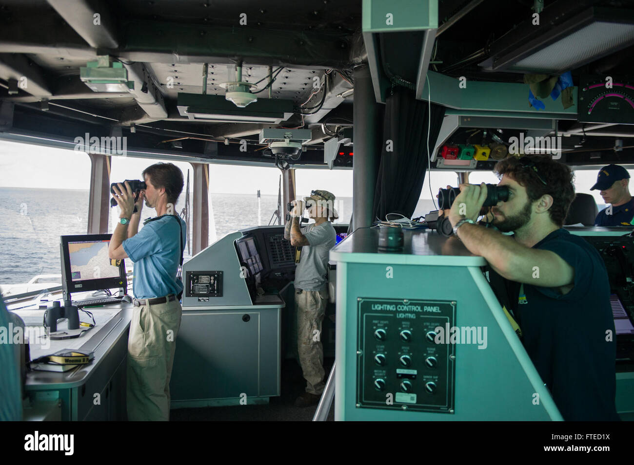 Mariners aboard the USNS Spearhead in the Gulf of Guinea monitor a ...