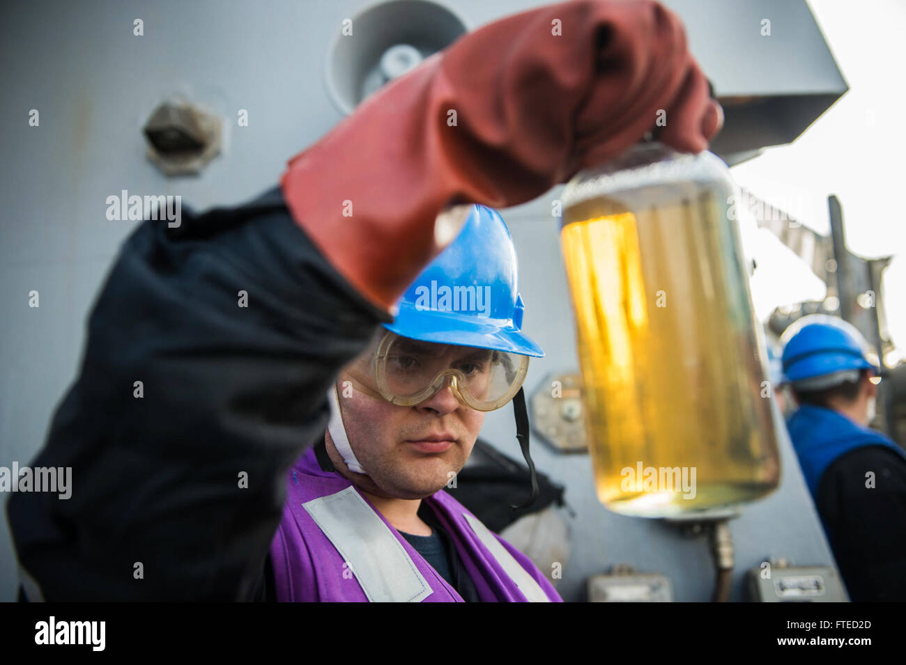 Fireman Casey Conway inspects a fuel sample aboard the USS Donald Cook ...