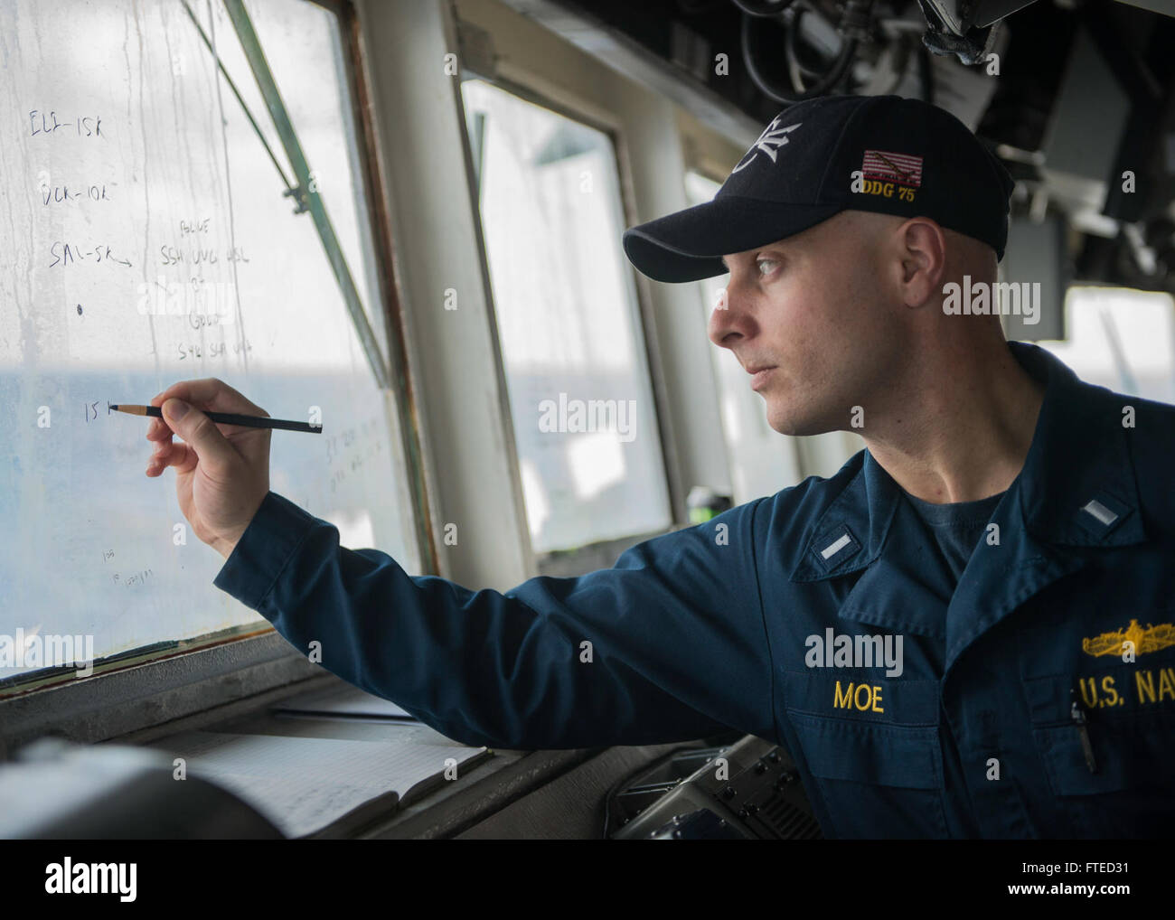 This U.S. Navy photograph shows Lt.j.g. Paul Moe marking navigation ...