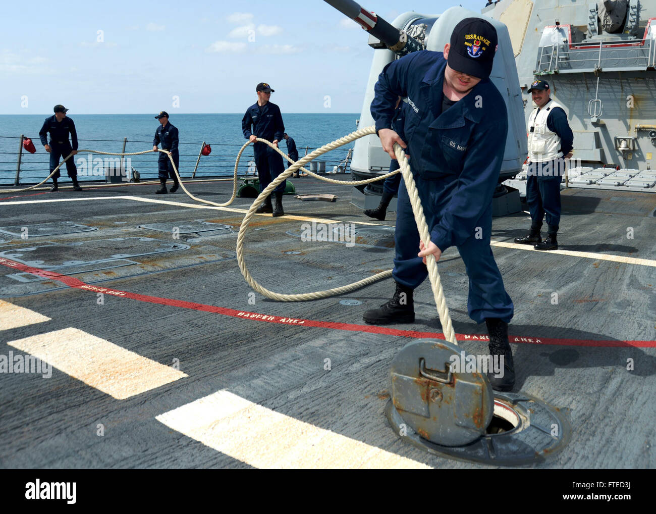 Sailors aboard the USS Ramage (DDG 61) prepare for their arrival in ...