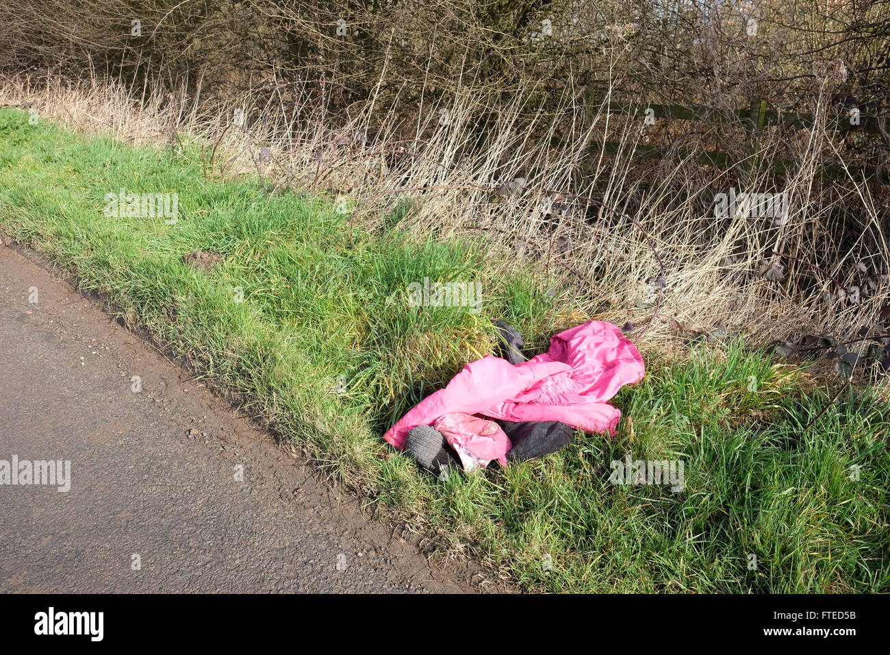 clothing dumped in the street Stock Photo - Alamy