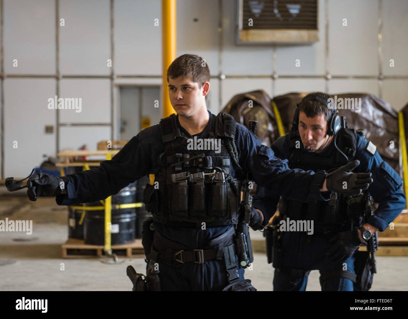 This image depicts U.S. Coast Guard specialists conducting a boarding ...