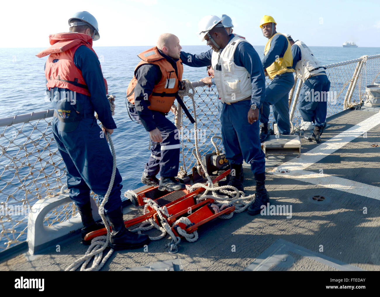 Chief Boatswain's Mate Anthony Matthews assists a French sailor onto ...