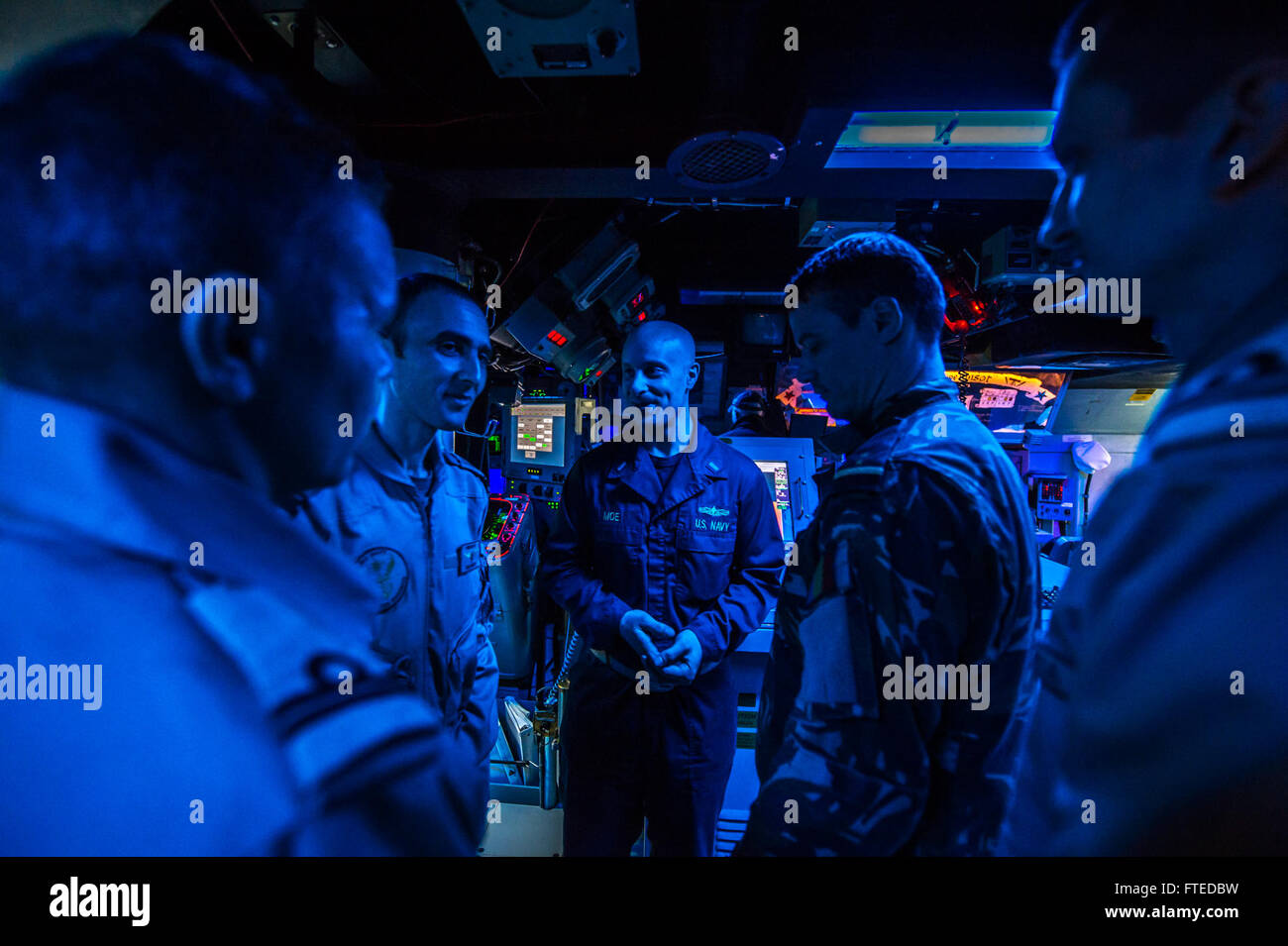 The image shows Lt. j.g. Paul Moe conducting a tour for Romanian navy ...