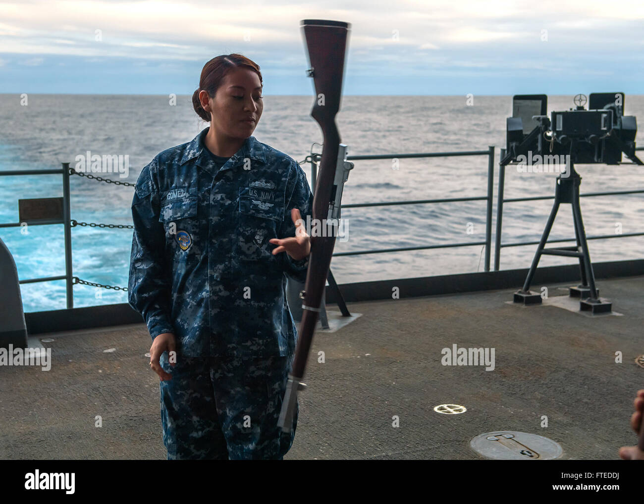 Seaman Dany Gomez practices with a ceremonial rifle during color guard ...