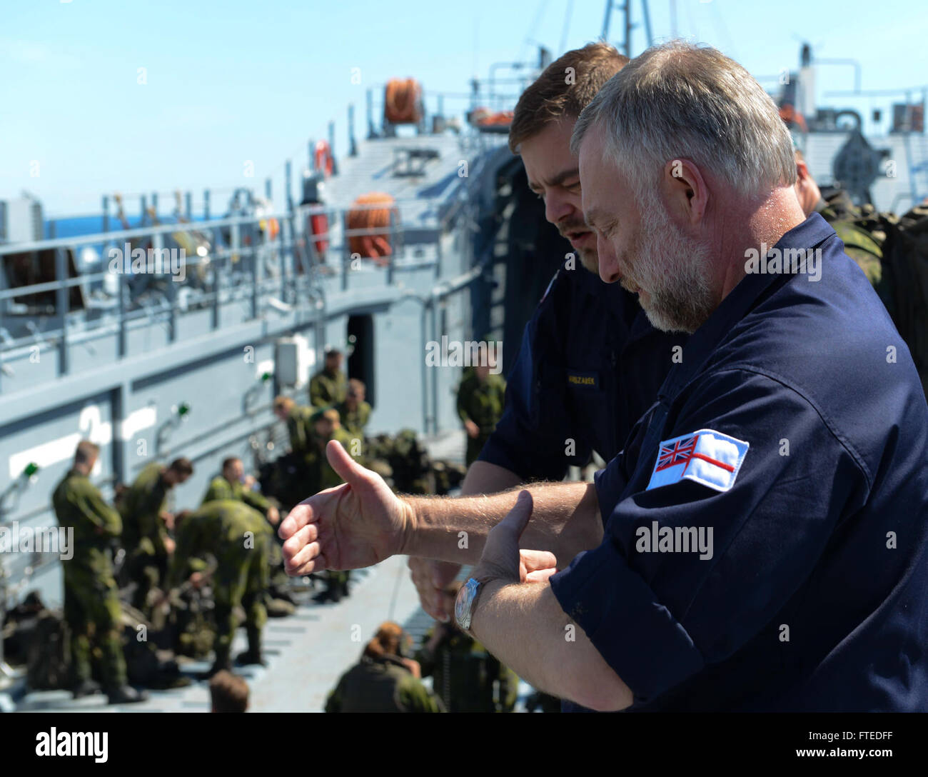 Rear Admiral Tim Lowe of the Royal Navy and Lt. Grzegorz Marzalek of ...
