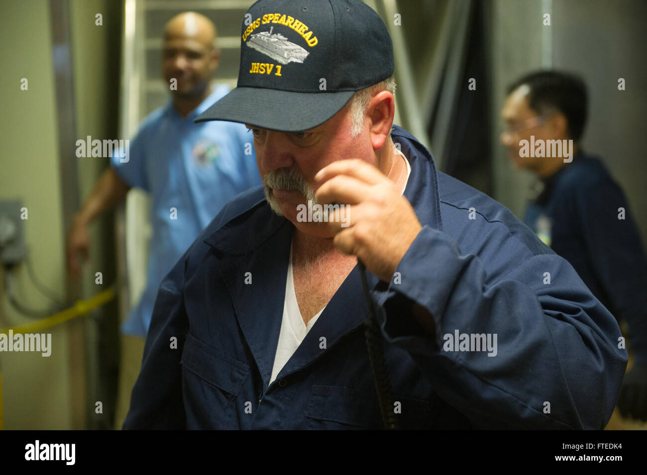In this image, U.S. Navy Able Seaman Mike Stickland coordinates during ...