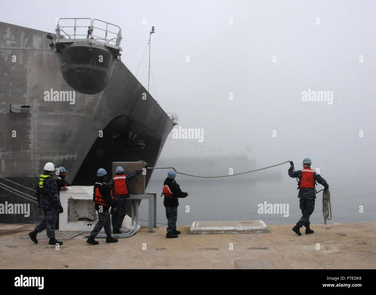 Line handlers at Naval Station Rota, Spain, prepare to moor the joint ...