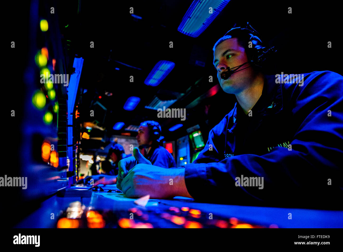 Sonar Technician 2nd Class Steven Gibson monitors a sonar console for ...
