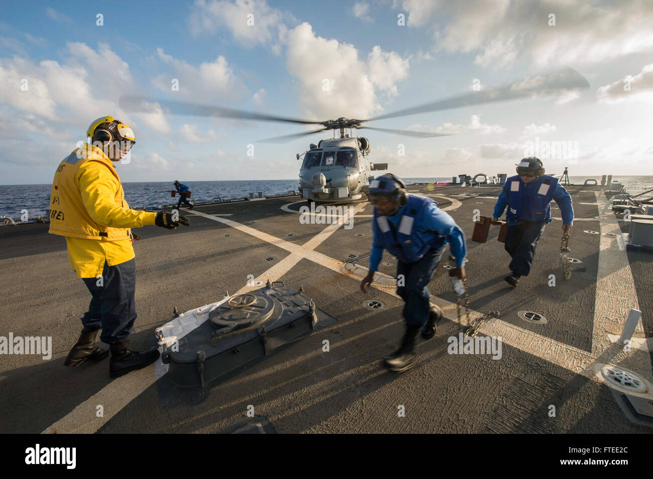 Sailors aboard the USS Donald Cook (DDG 75) conduct helicopter ...