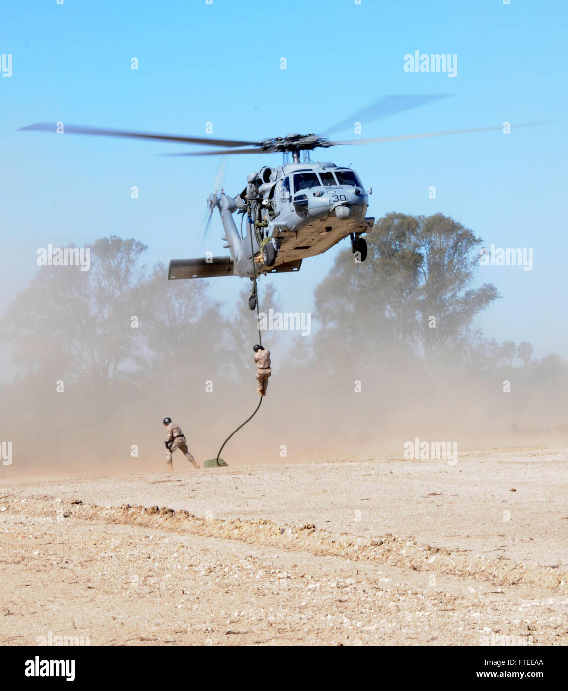 A Spanish Explosive Ordnance Disposal (EOD) sailor fast-ropes from a UH ...