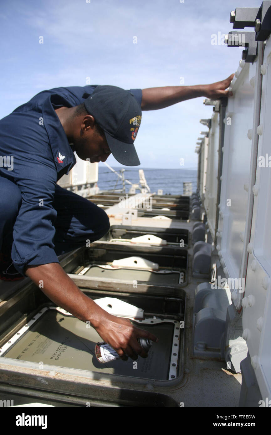 Gunner's Mate 2nd Class Anjoe Jeffers is seen conducting maintenance on ...