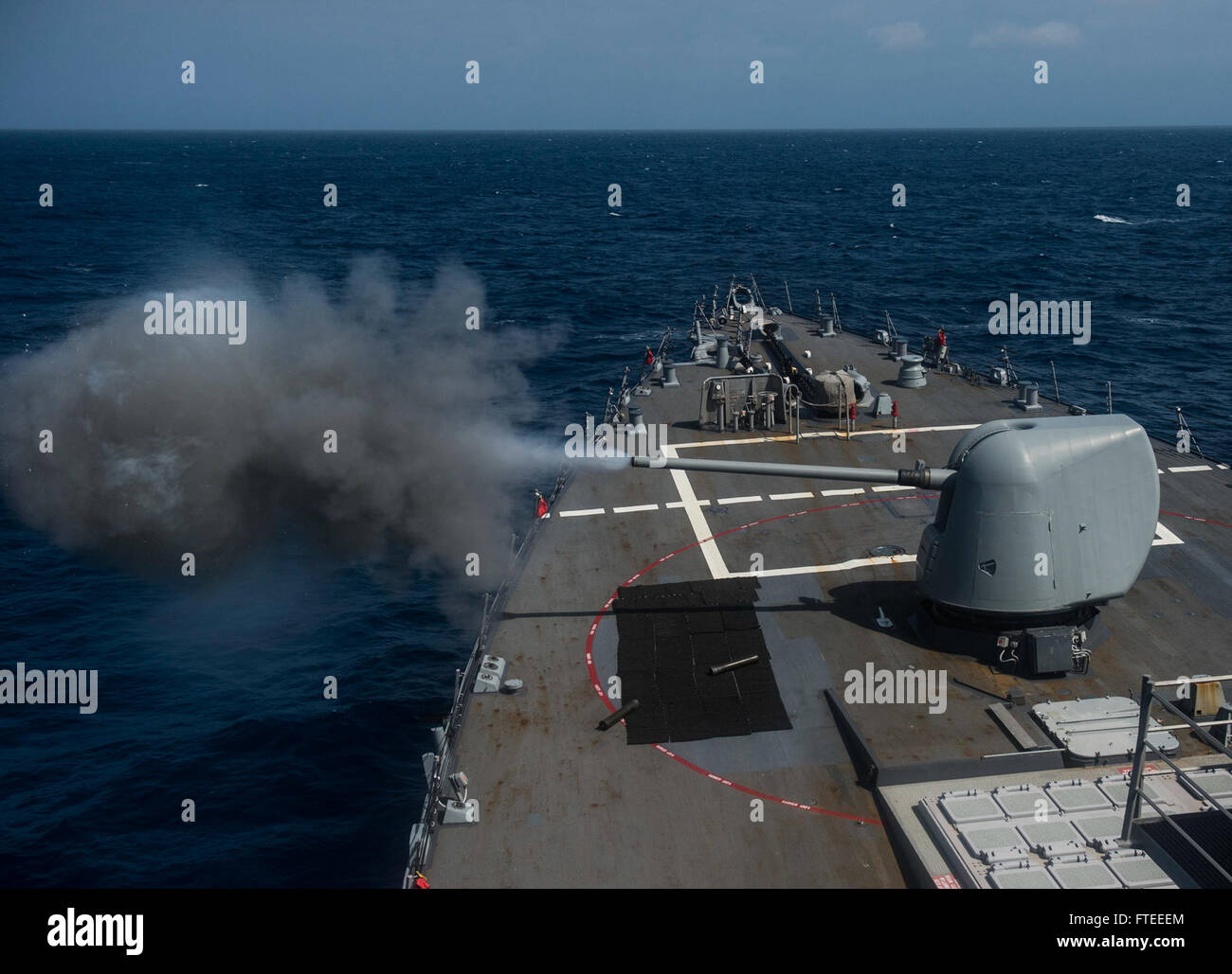 This image captures the USS Oscar Austin (DDG 79) firing its 5-inch gun ...