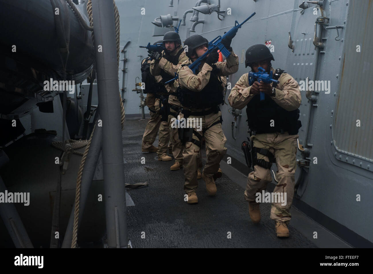 A U.S. Navy boarding team practices tactical movements aboard the USS ...