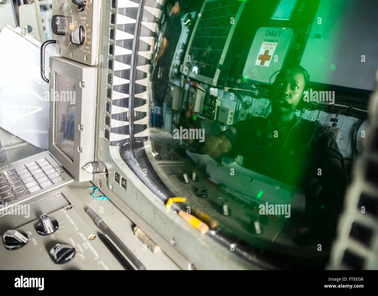 Seaman Enmanuel Gnahoui David of the USS Vella Gulf (CG 72) monitors ...