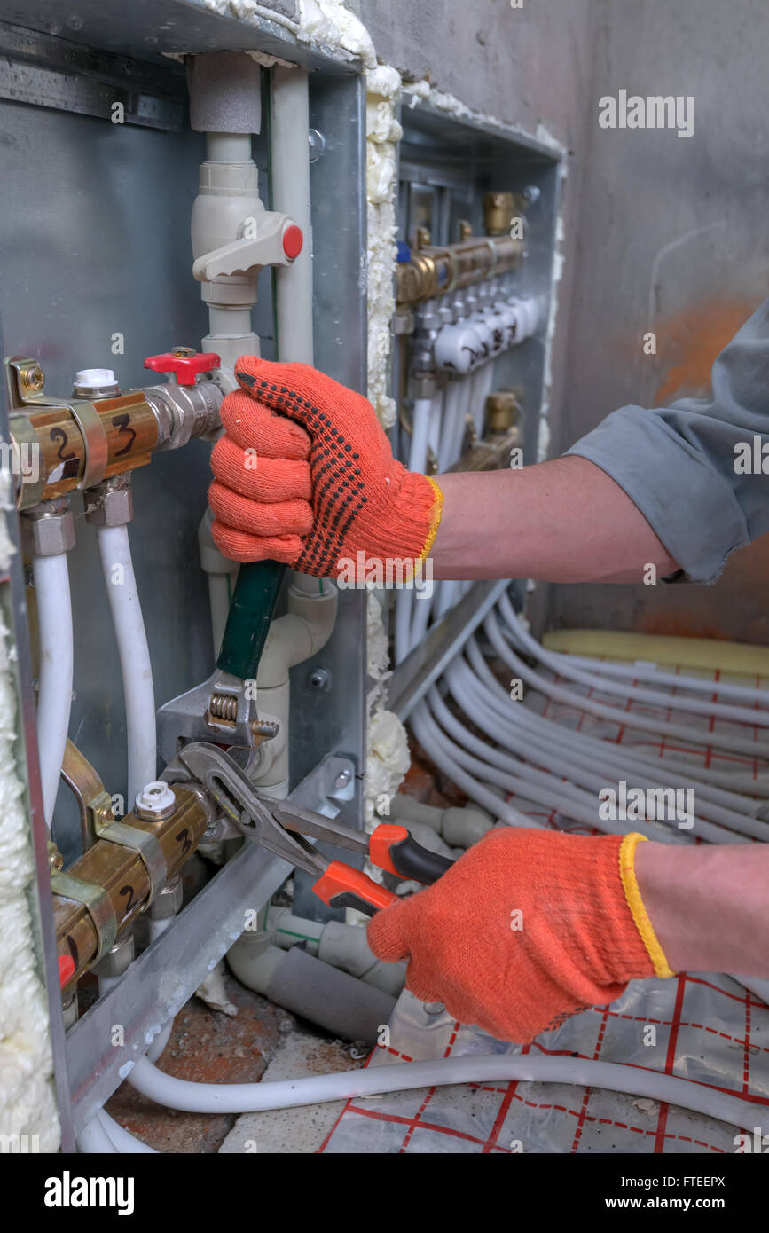 pipefitter installing system of heating Stock Photo - Alamy