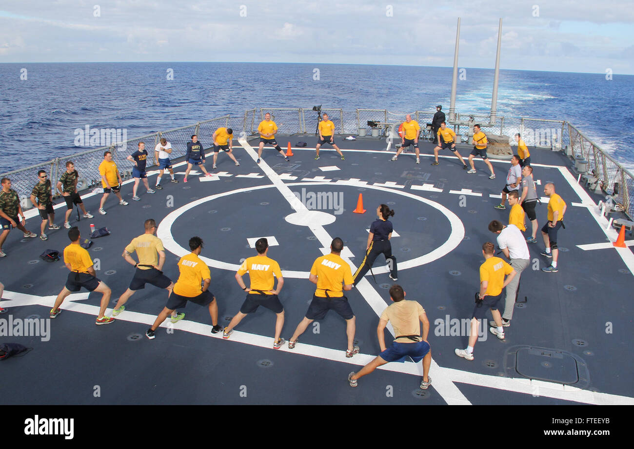 Sailors aboard the USS Ross (DDG 71) exercise on the fantail of the ...