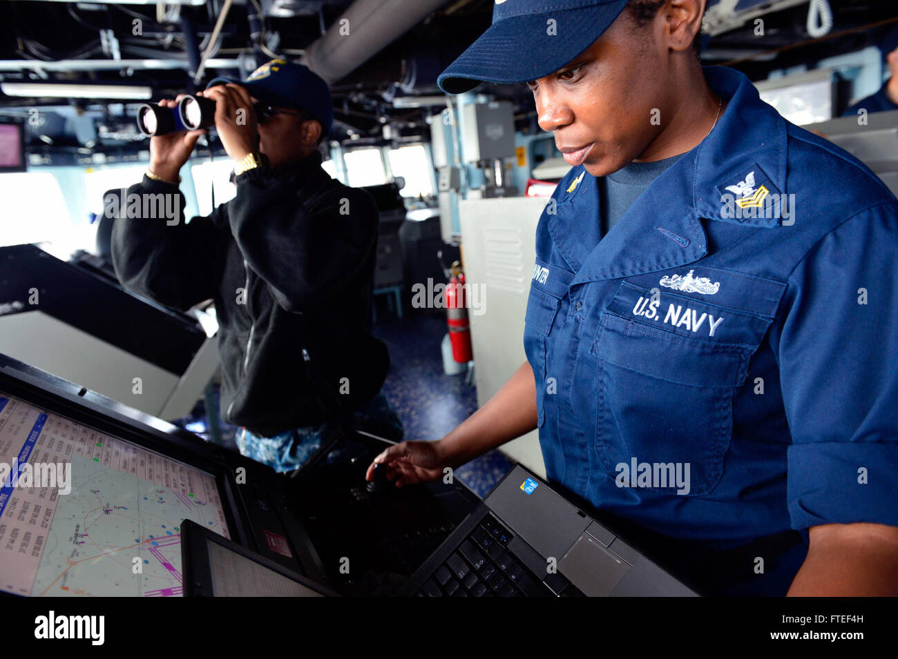 Quartermaster 1st Class Ebony Hunter monitors the navigation systems ...