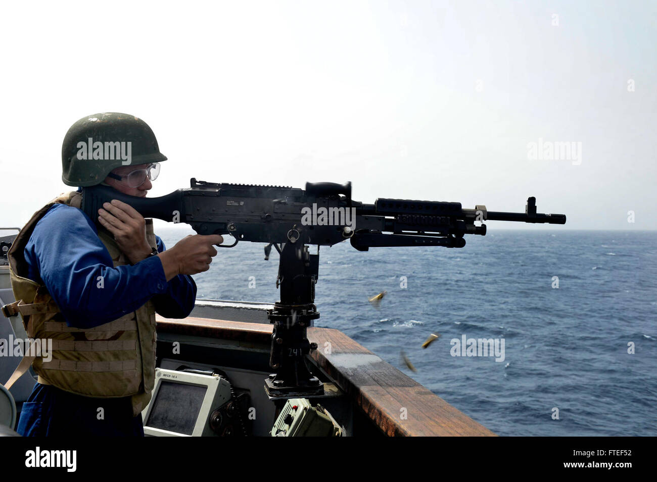 Ensign Heriberto Cruz of the USS Nitze (DDG 94) fires a 240-caliber ...