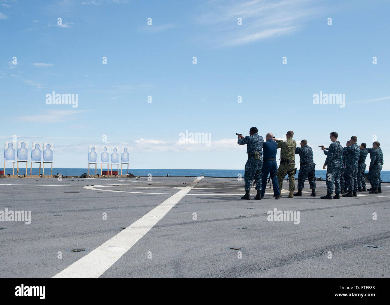 This image shows sailors aboard the USS Mount Whitney (LCC-20) engaging ...