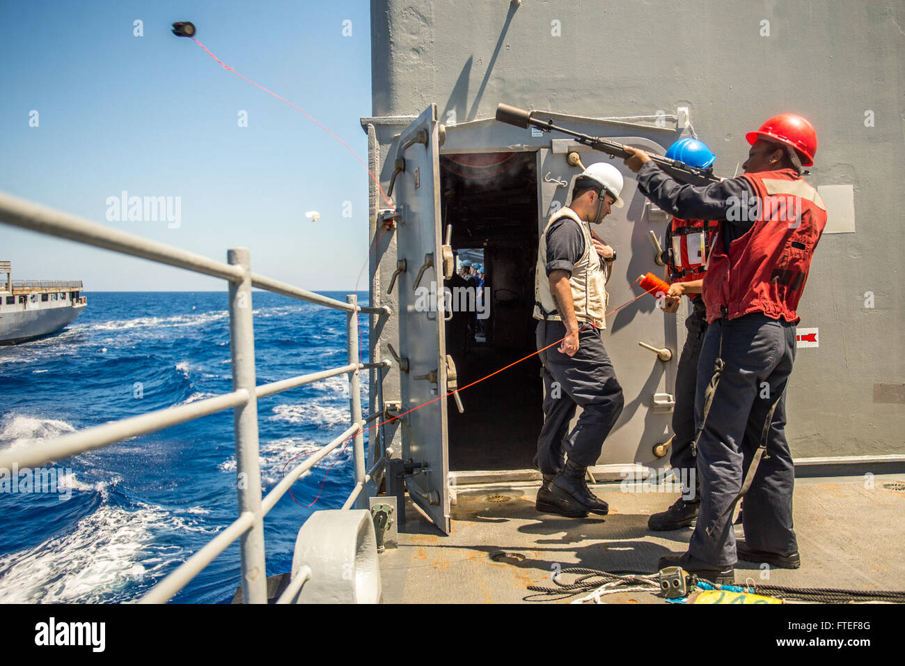 This image shows Gunner's Mate 1st Class Tamara Gilbert firing a shot ...