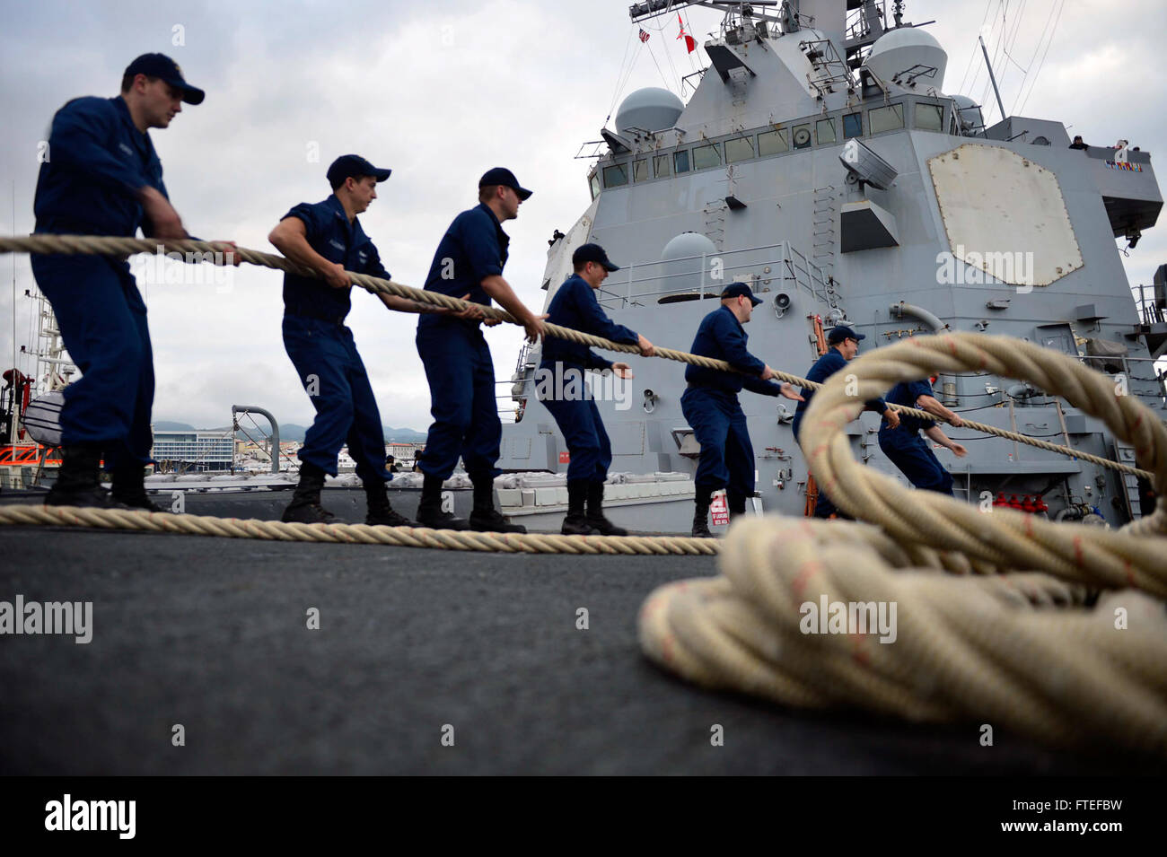 Sailors aboard USS Nitze (DDG 94) secure mooring lines as the guided ...