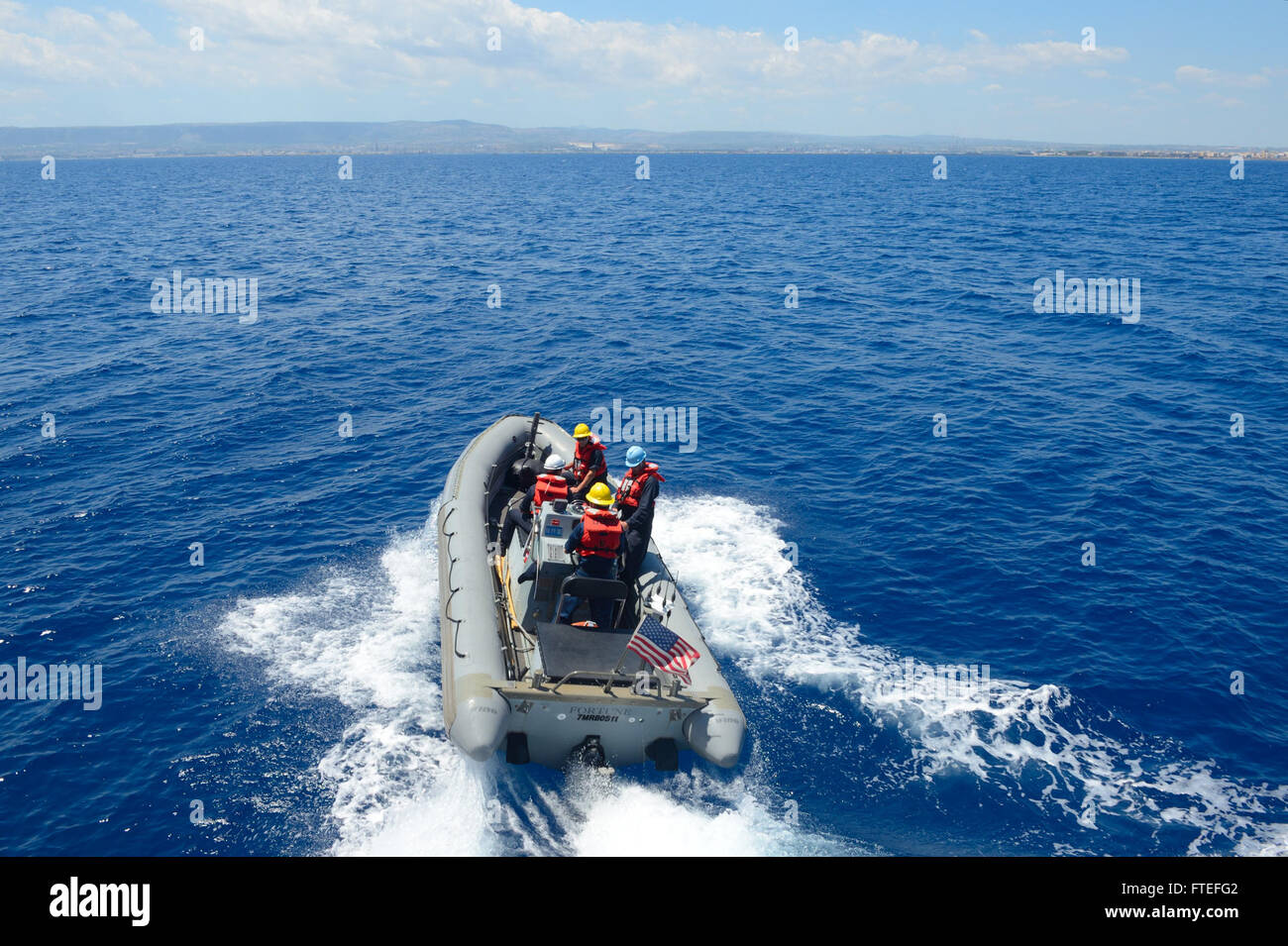Boatswain's Mate 2nd Class James Cornelia pilots a ridge hull ...