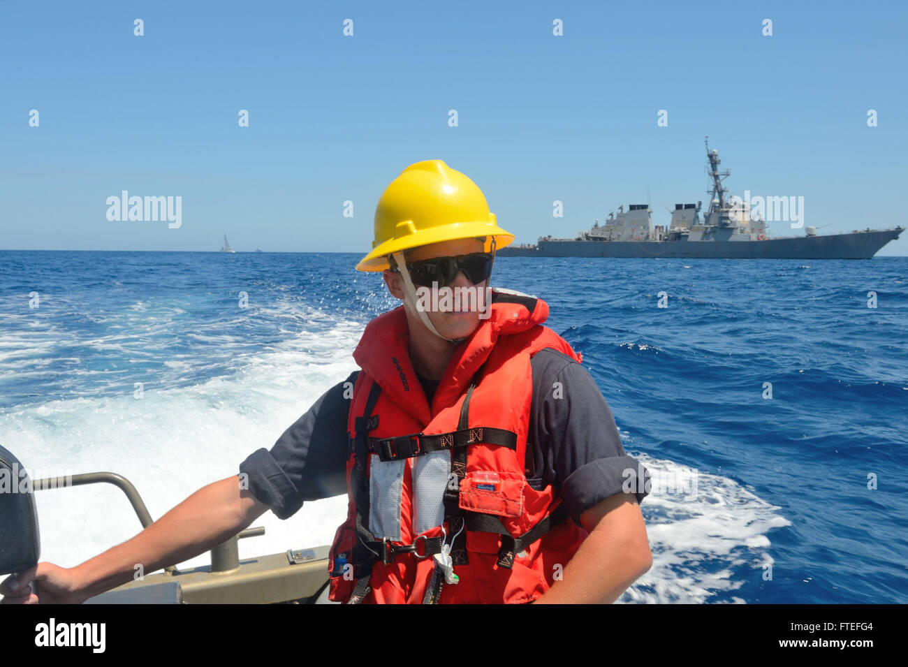 On July 24, 2014, Boatswain's Mate 3rd Class Zachary Putnam sits aboard ...