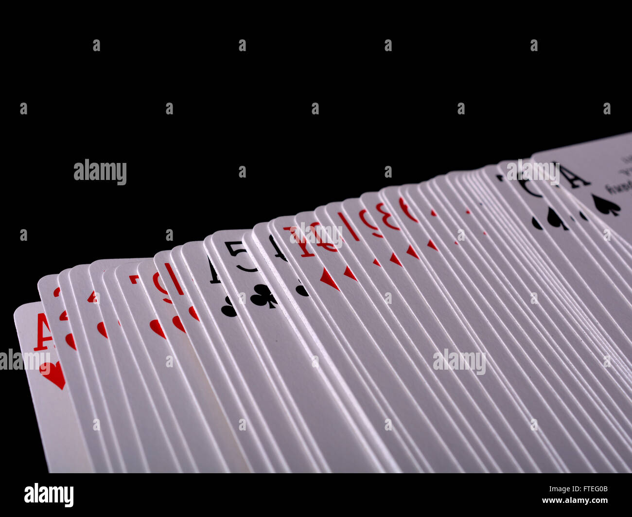 Deck of playing cards close up on black background Stock Photo - Alamy